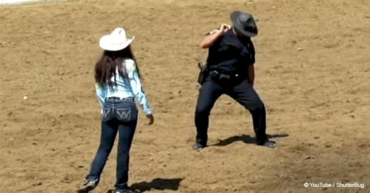 Cop takes part in a dance battle with a cowgirl making the Rodeo erupt ...