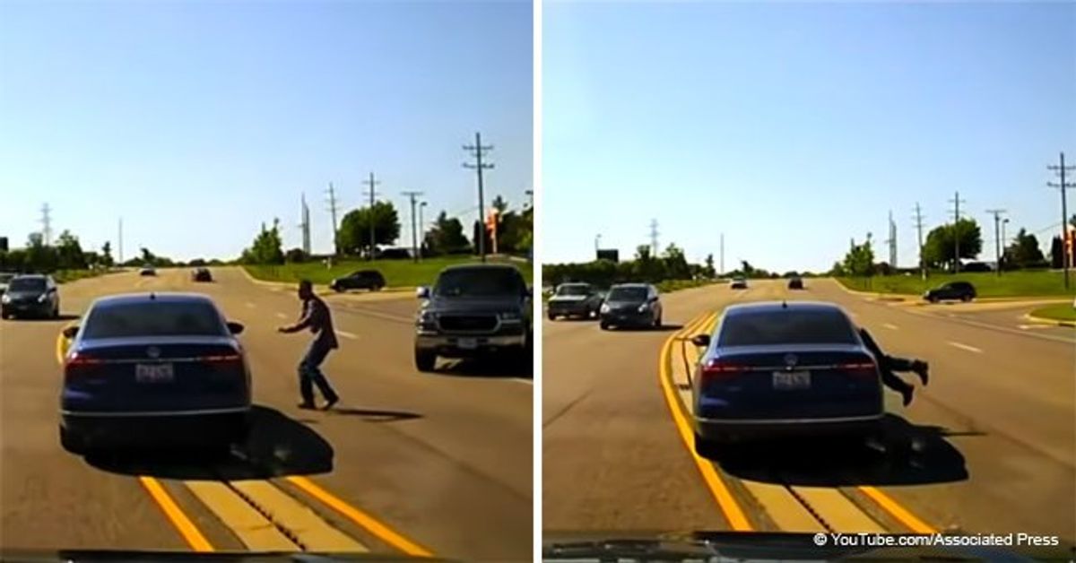 A man dives head-first into the moving car of a driver having a seizure