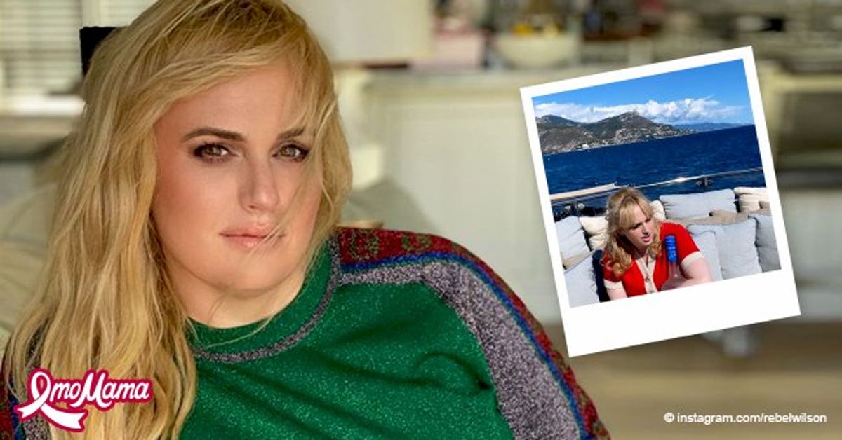 Rebel Wilson Looks Slim in Red Dress as She Holds a Liquor Bottle in a ...