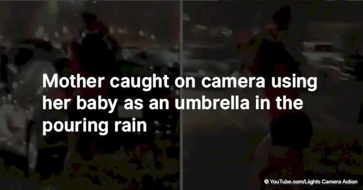 Mother caught on camera using her baby as an umbrella in the pouring rain