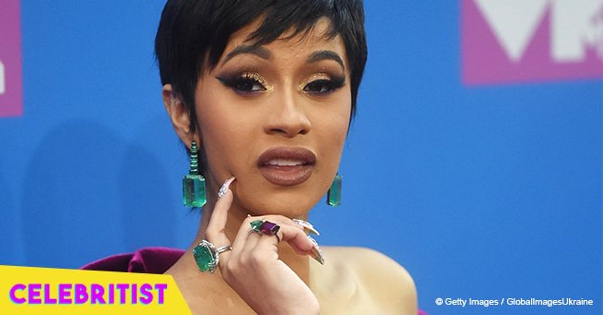 Cardi B shows off deep cleavage in purple gown with high slit at post ...