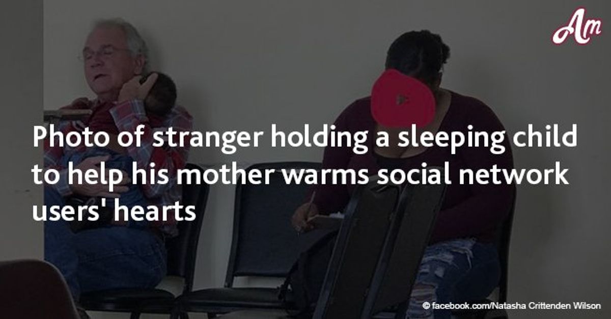 Photo of stranger holding a sleeping child to help his mother warms ...