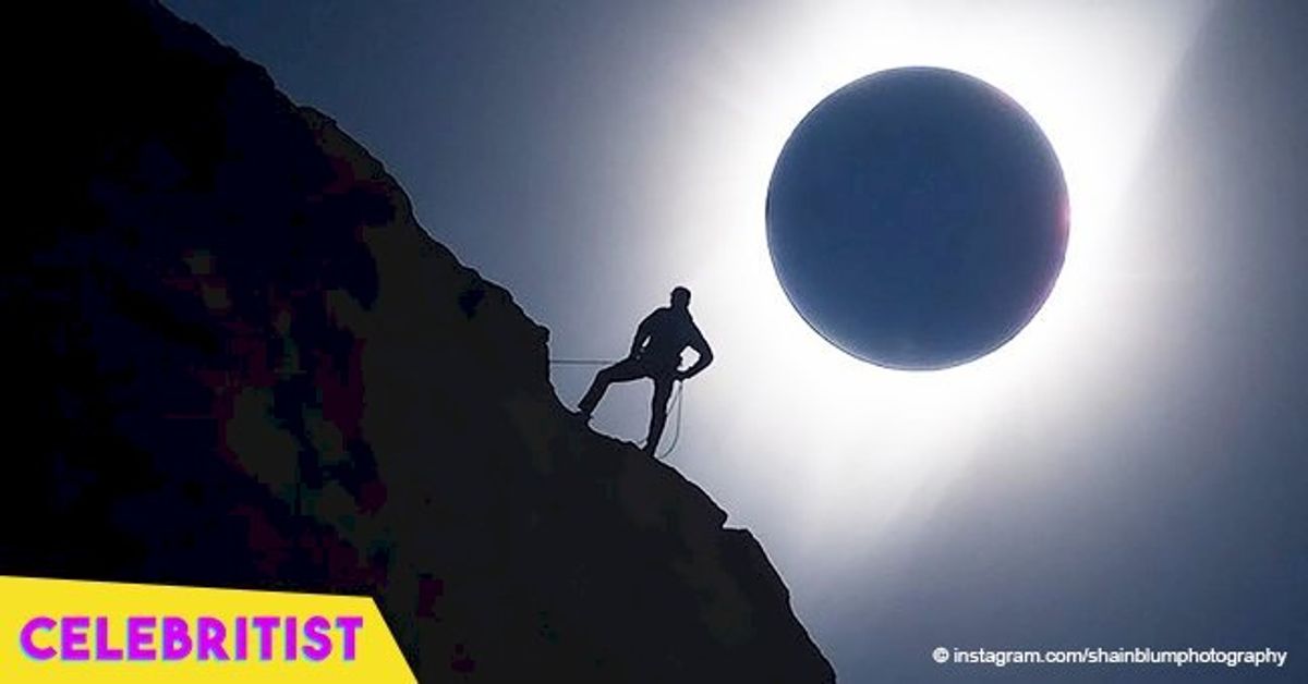 Photo of a rock climber posing in front of a total solar eclipse has ...